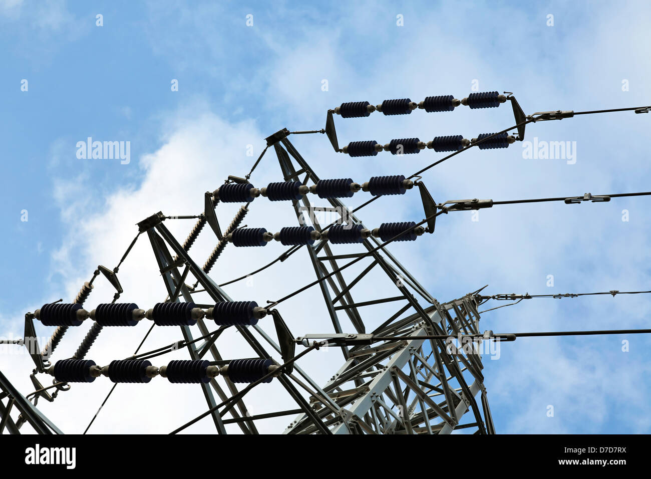 Low angle close up top part an electricity pylon featuring its large ...