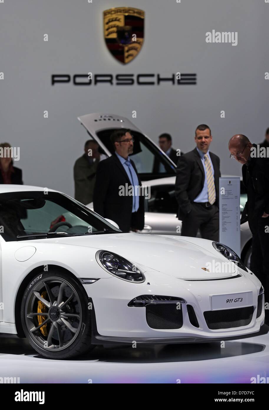 Shareholders of Porsche SE stand around a Porsche 911 GT3 during the ...