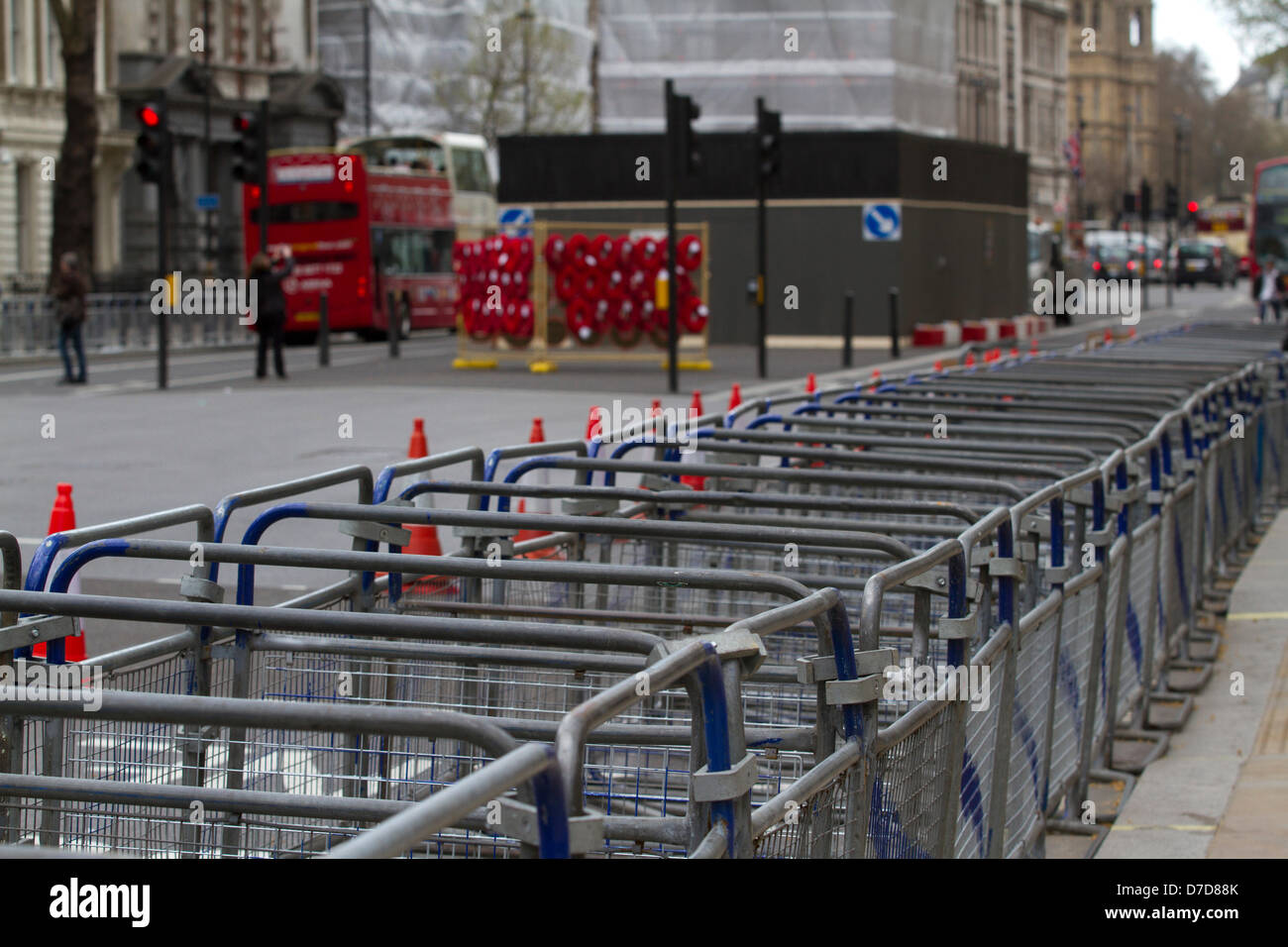 London, UK. 4th May 2013. Workmen help police support officers to erect ...
