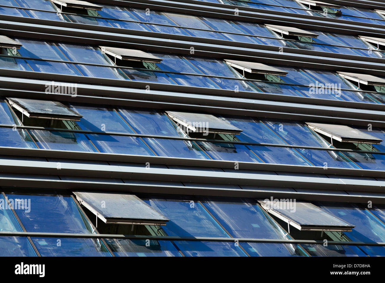 Low angle view at building's curtain wall most its windows identically ...