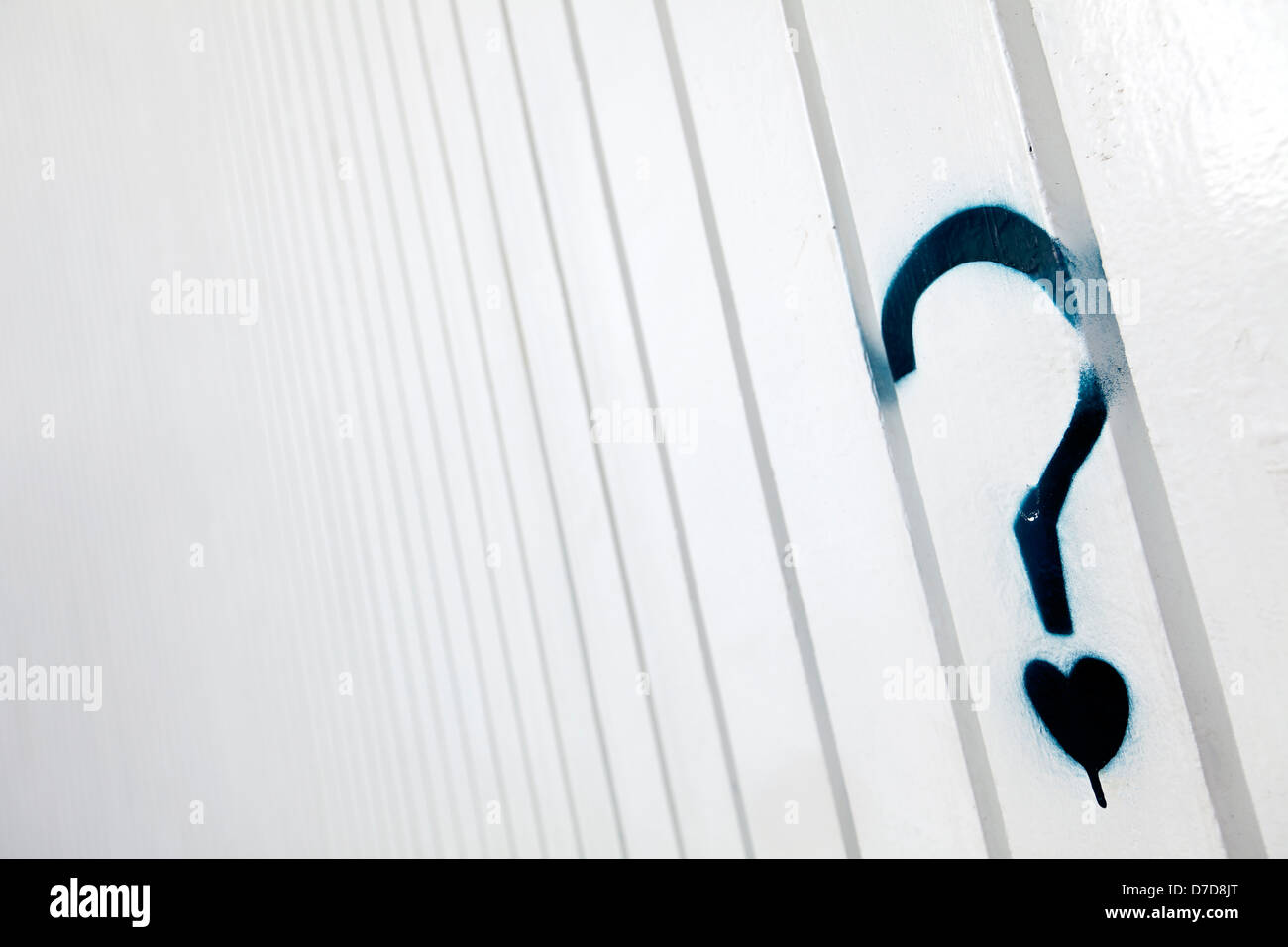 A blue grafitti in shape question mark small heart instead dot on white ...