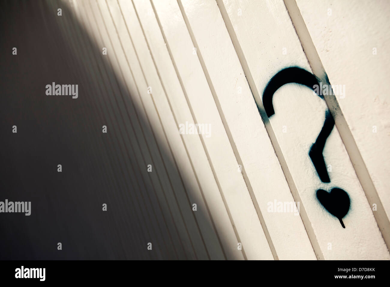 A blue grafitti in shape question mark small heart instead dot on white ...