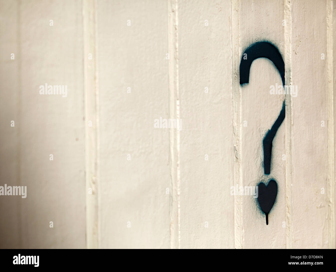 A blue graffiti in shape question mark small heart instead dot on white ...