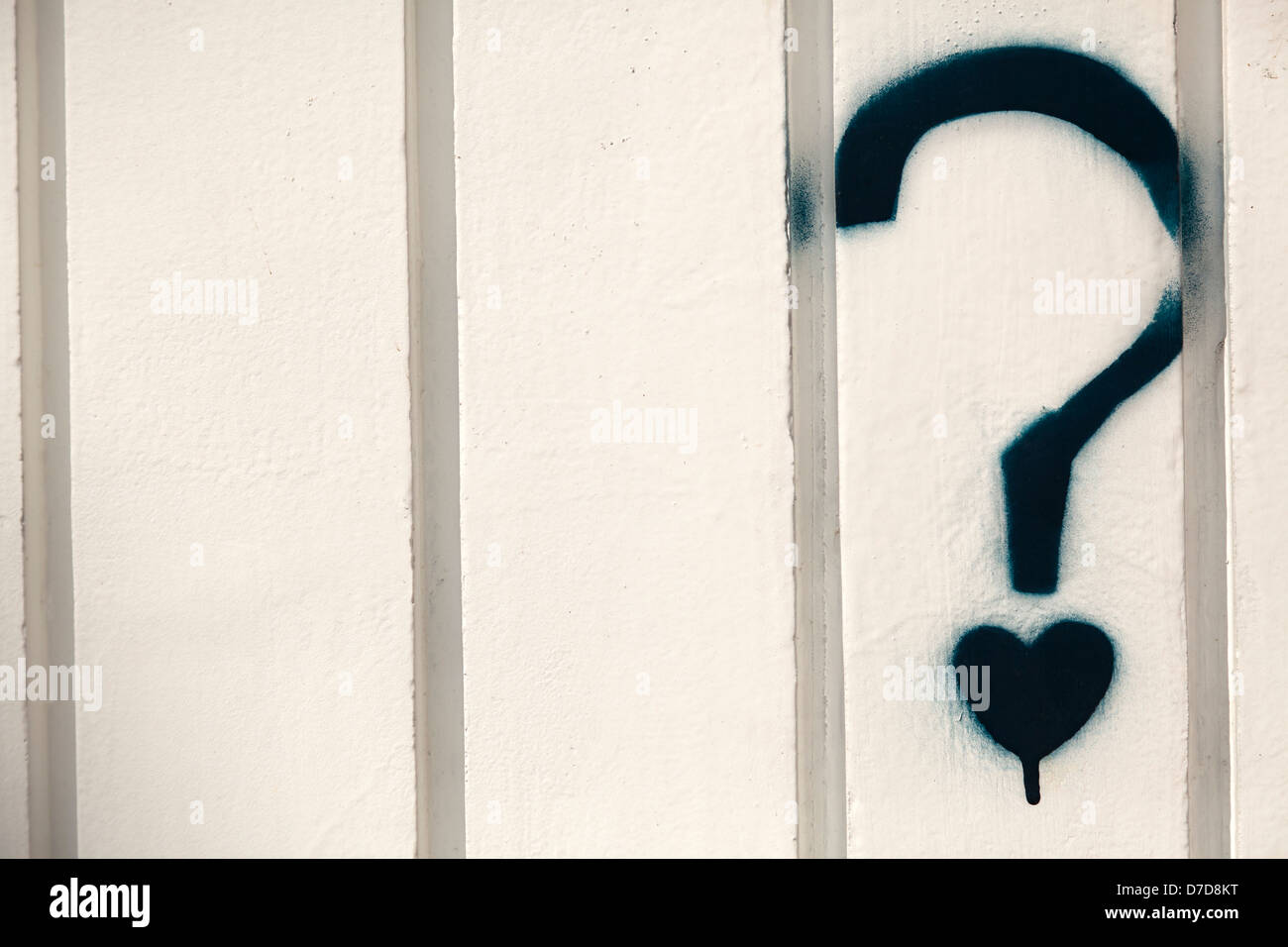 A blue grafitti in shape question mark small heart instead dot on white ...