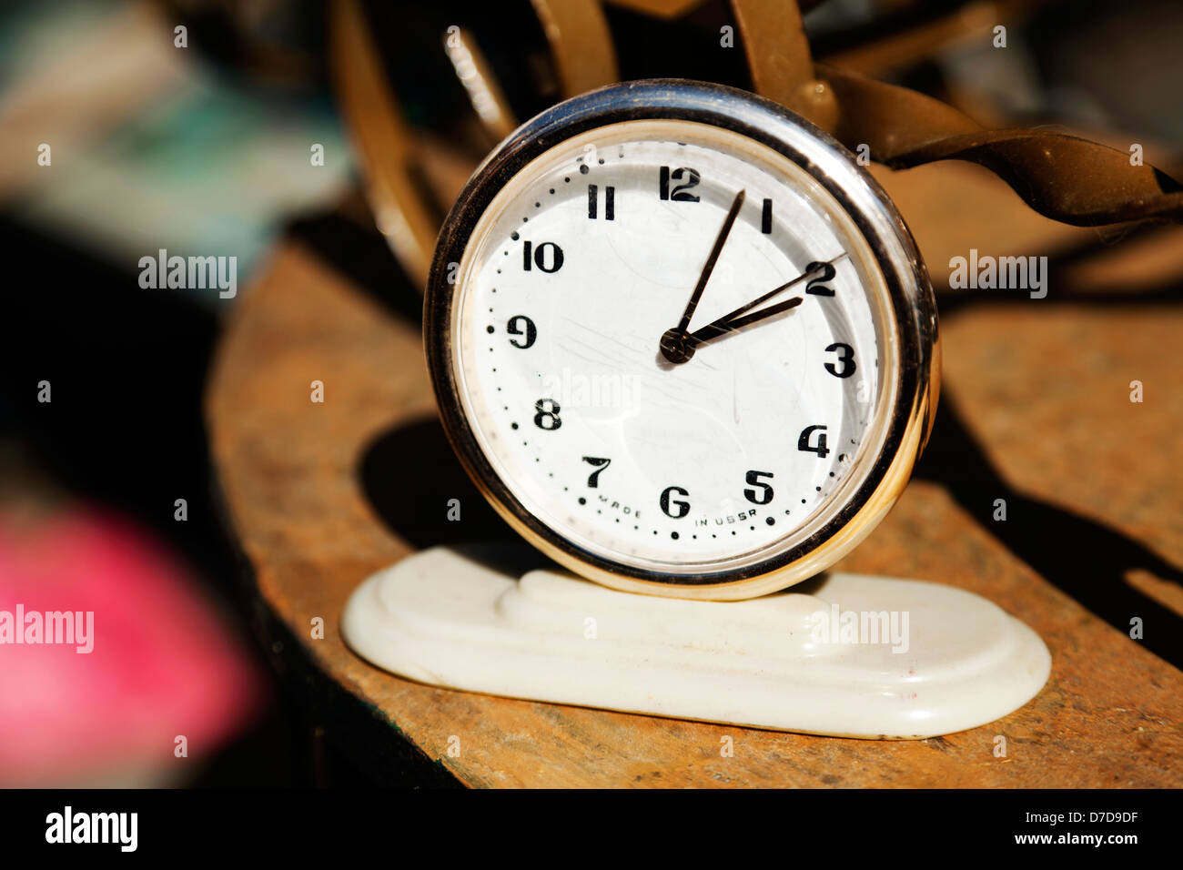 Small second-hand clock made in the USSR, displayed for sale at a flea ...