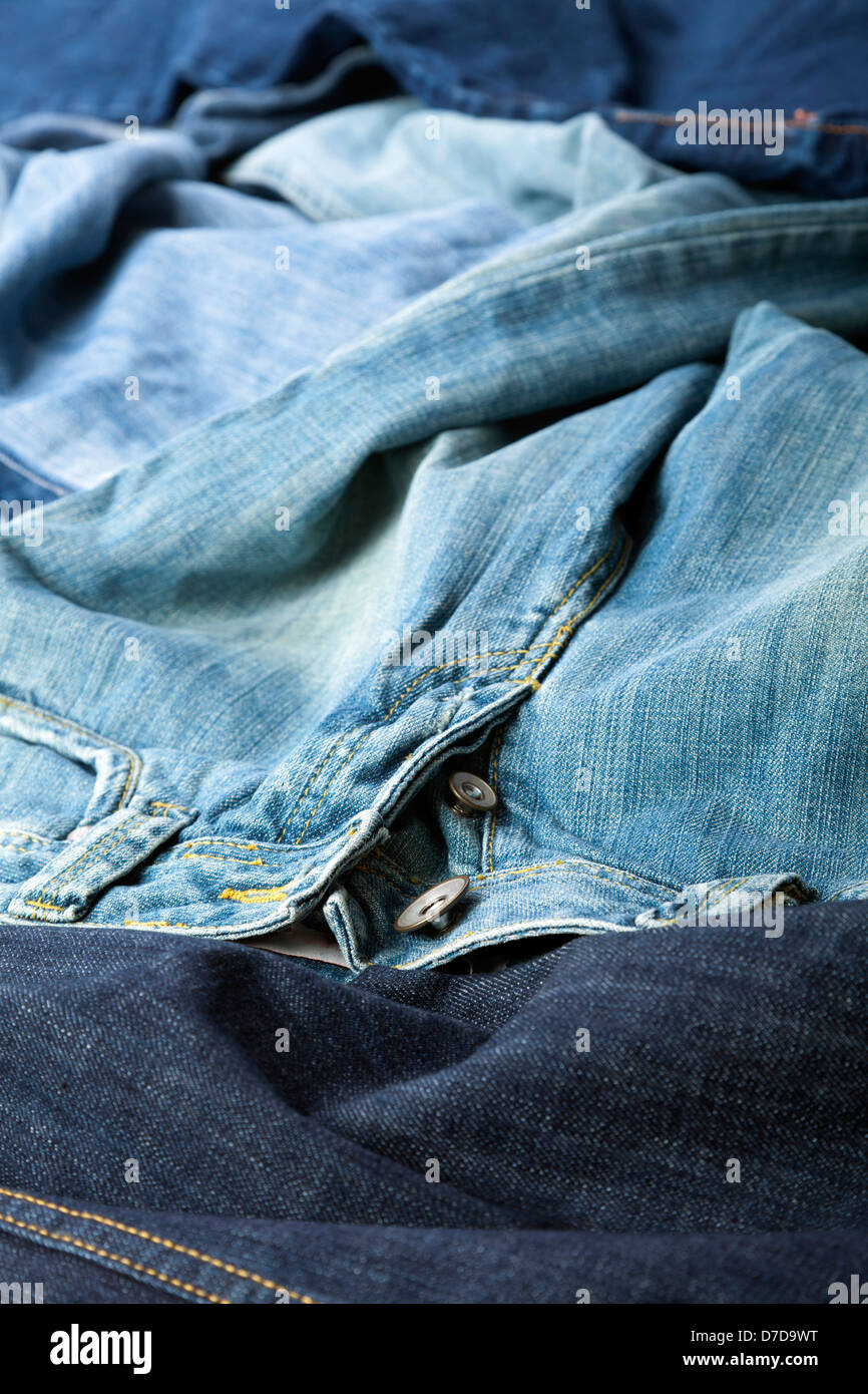 Various pairs of jeans pants scattered in chaos Stock Photo - Alamy