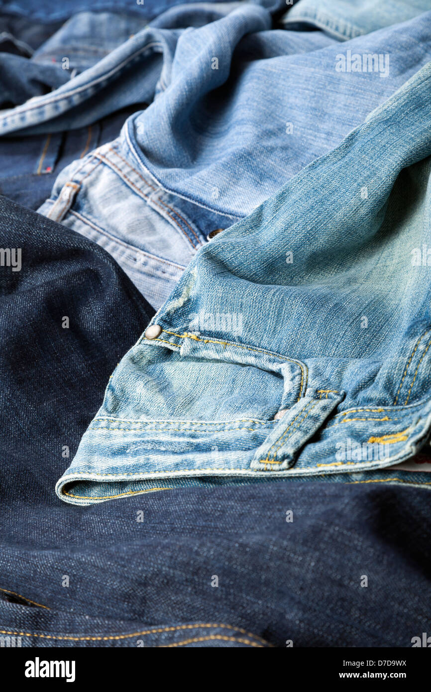 Various pairs of jeans pants scattered in chaos Stock Photo - Alamy