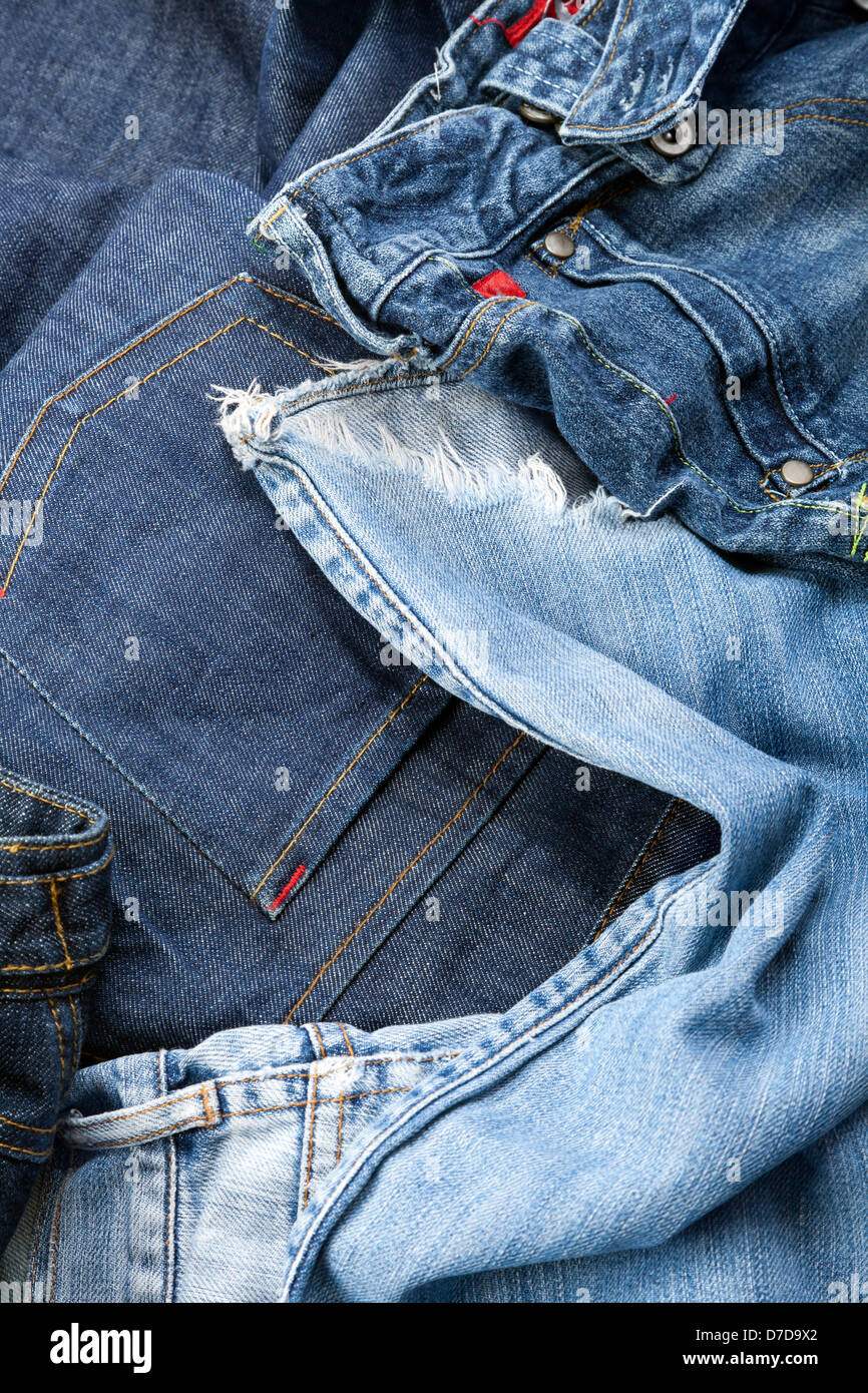 Various pairs of jeans pants scattered in chaos Stock Photo - Alamy