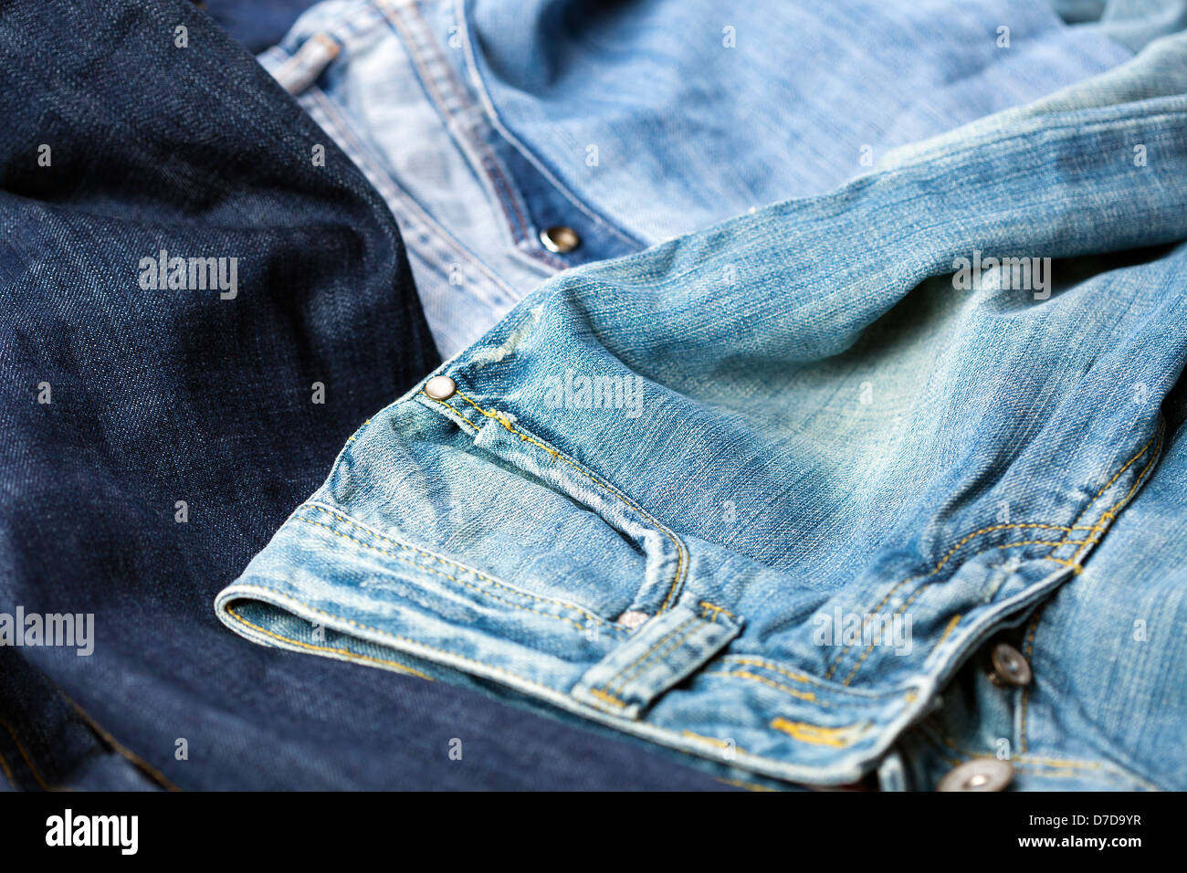 Various pairs of jeans pants scattered in chaos Stock Photo - Alamy