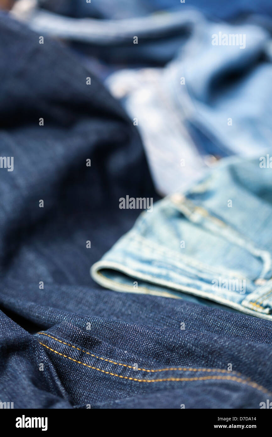 Various pairs of jeans pants scattered in chaos Stock Photo - Alamy