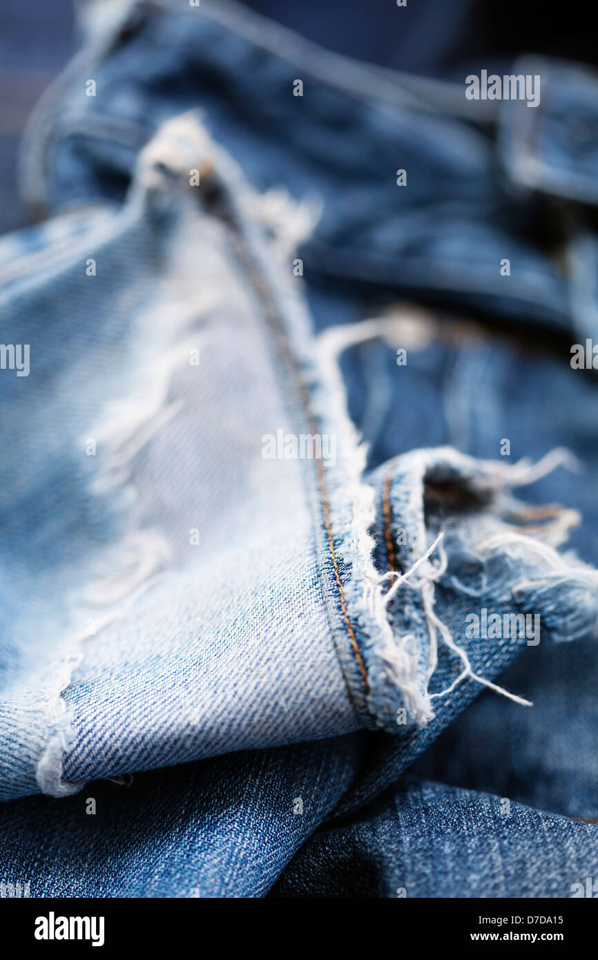 Various pairs of jeans pants scattered in chaos Stock Photo - Alamy