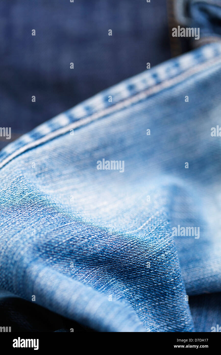 Various pairs of jeans pants scattered in chaos Stock Photo - Alamy
