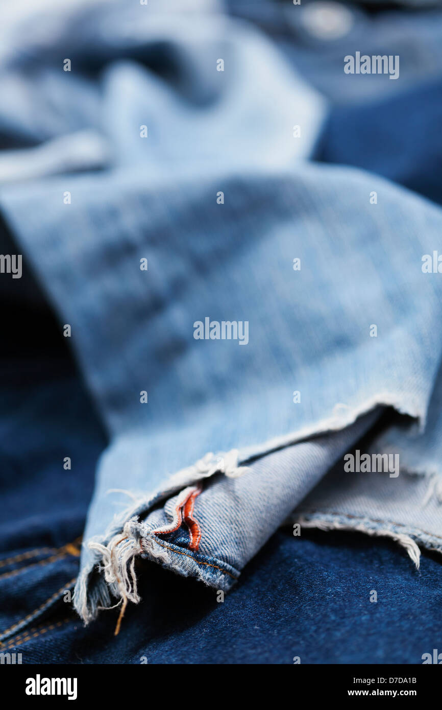 Various pairs of jeans pants scattered in chaos Stock Photo - Alamy