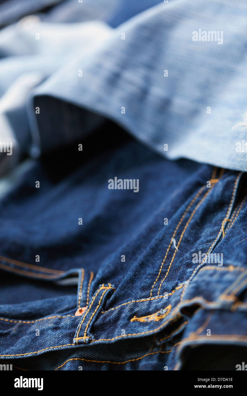 Various pairs of jeans pants scattered in chaos Stock Photo - Alamy