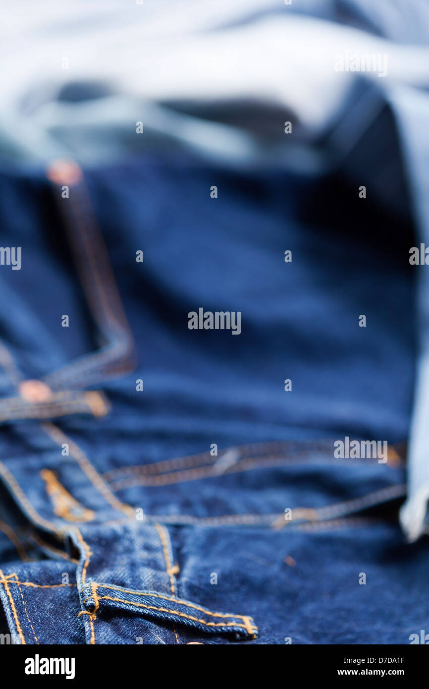 Various pairs of jeans pants scattered in chaos Stock Photo - Alamy