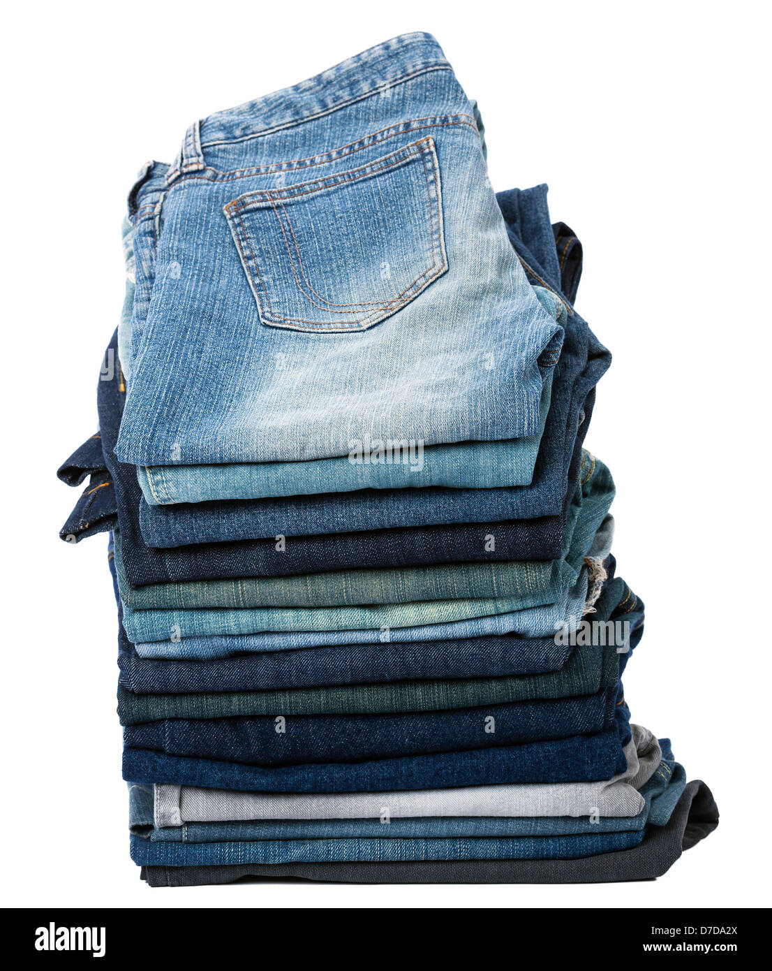 A stack of various pairs of jeans pants isolated on white background ...