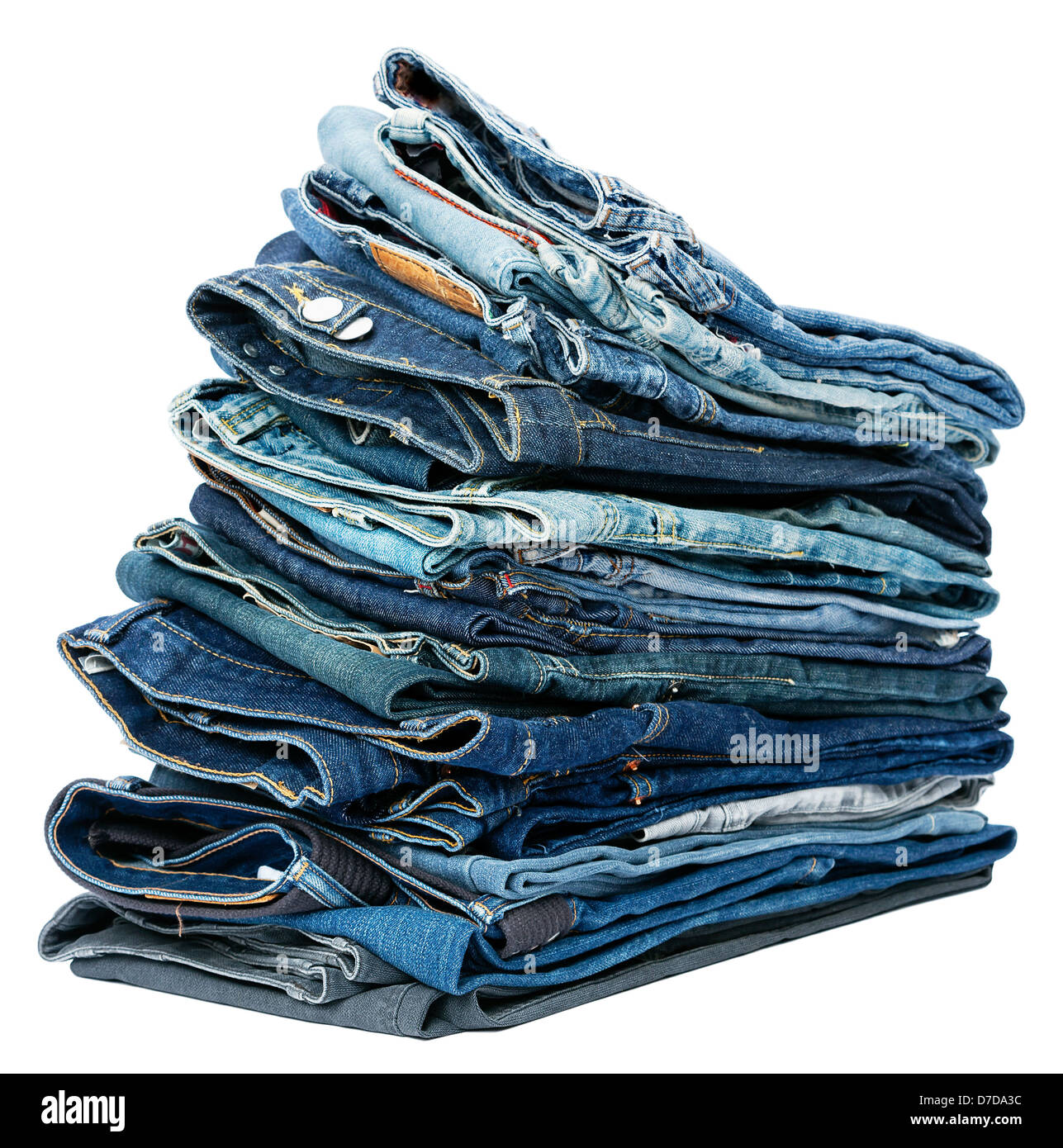 A stack of various pairs of jeans pants isolated on white background ...