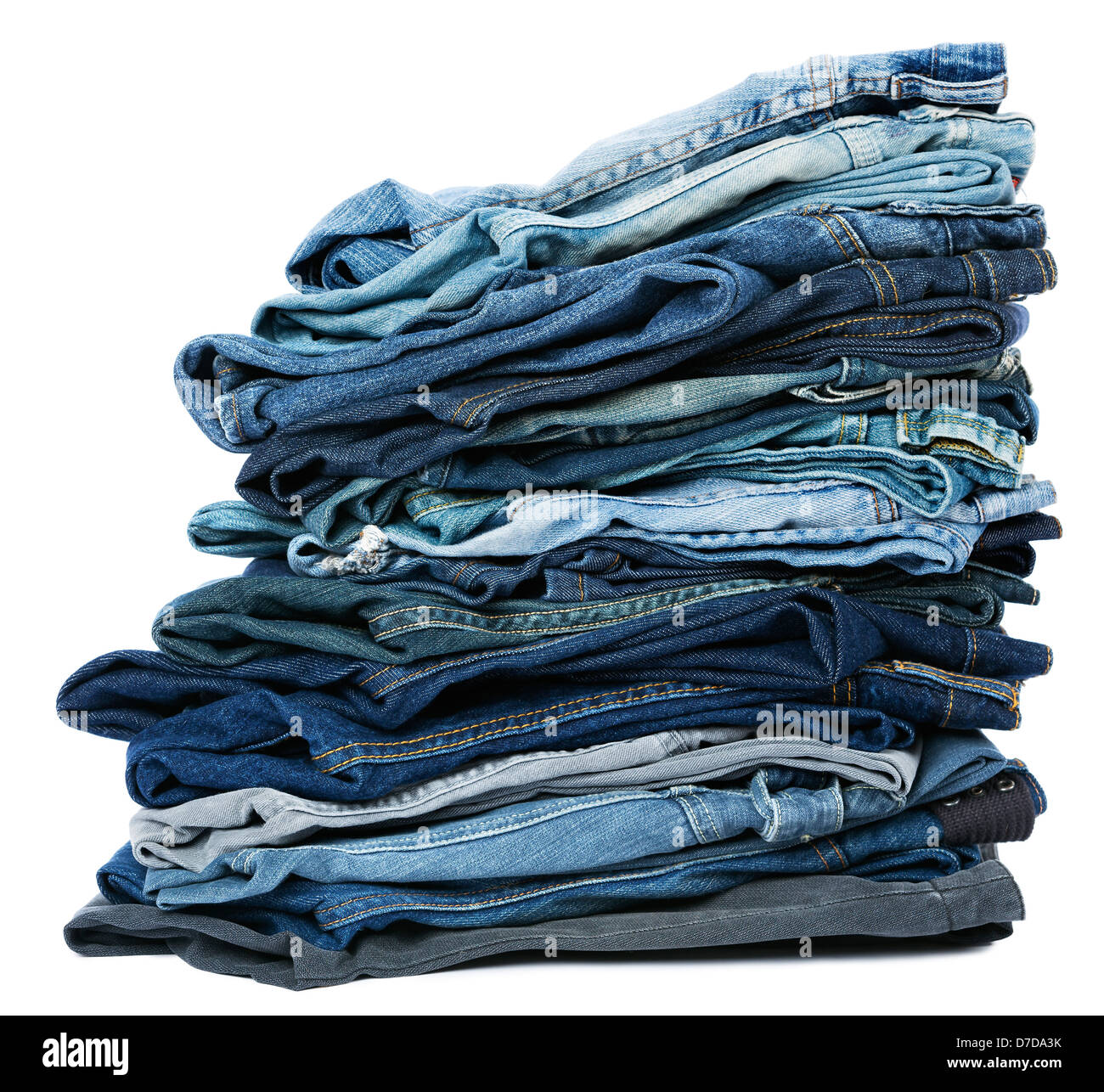 A stack of various pairs of jeans pants isolated on white background ...