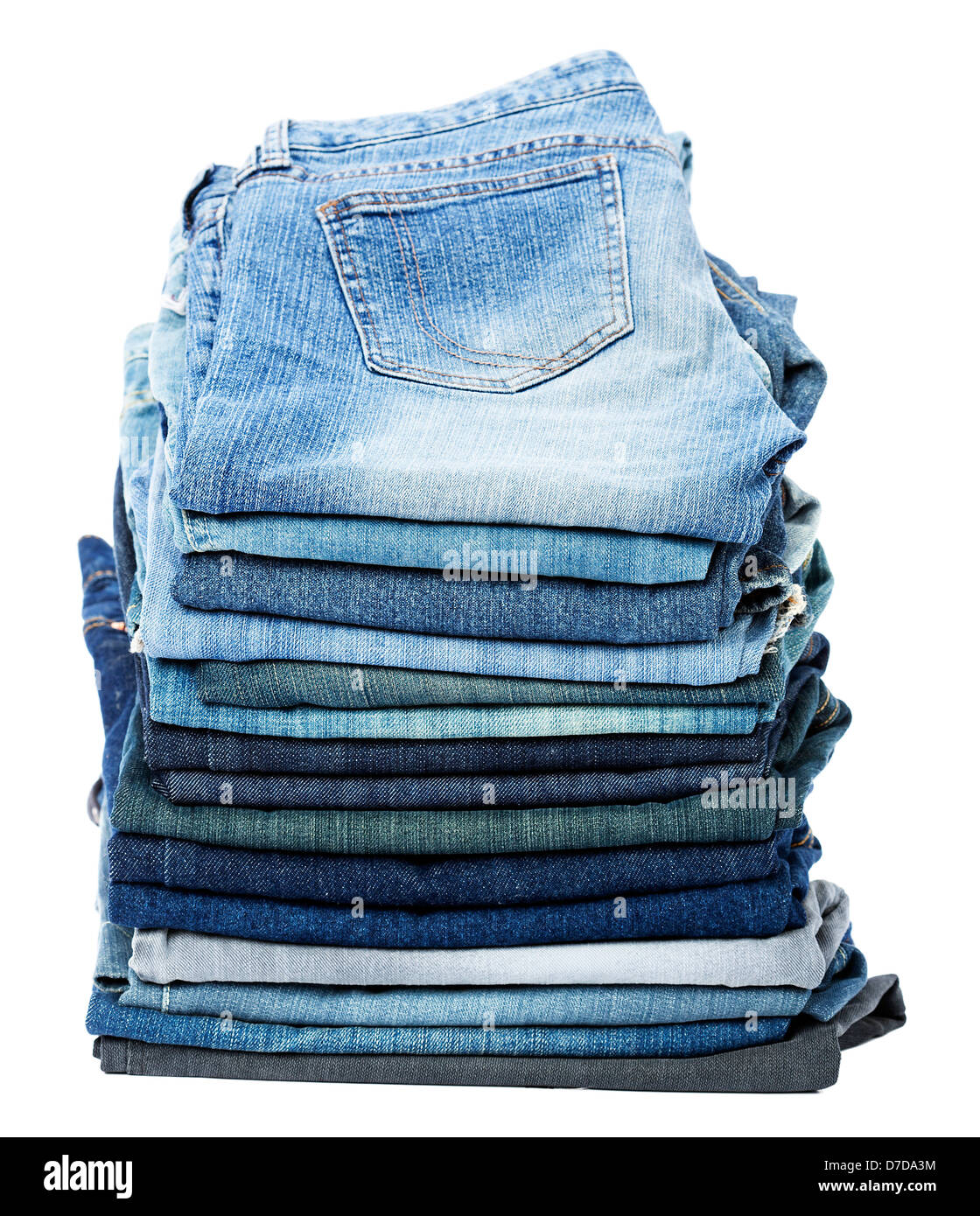 A stack of various pairs of jeans pants isolated on white background ...