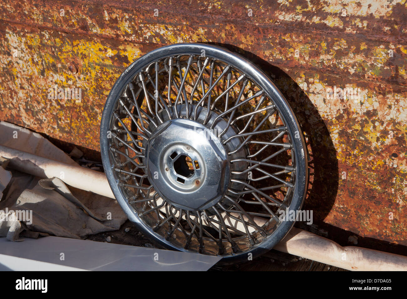 A rim in front of an old rusty historic cars at route 66 in Hackberry ...