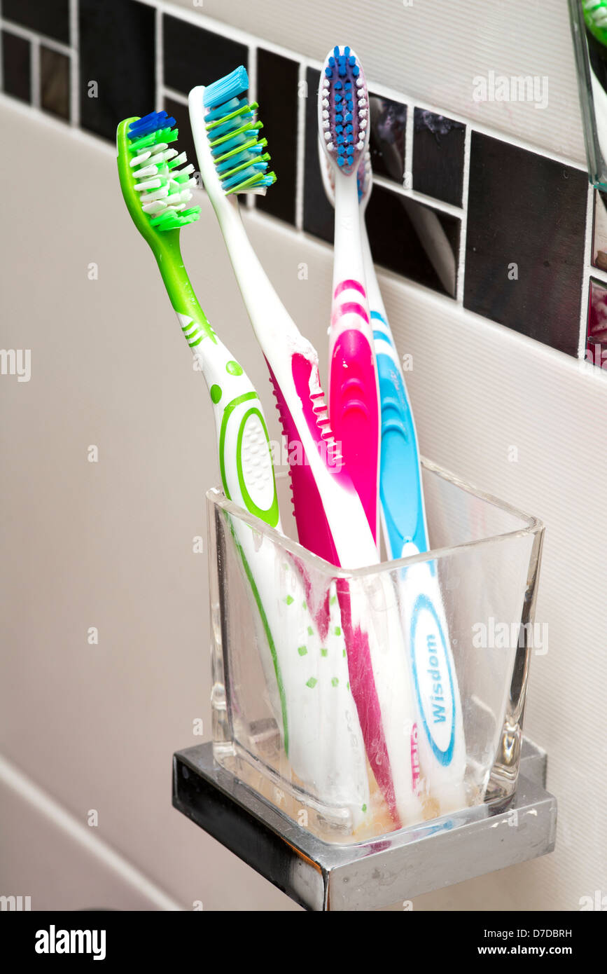 Toothbrushes in a cup Stock Photo - Alamy