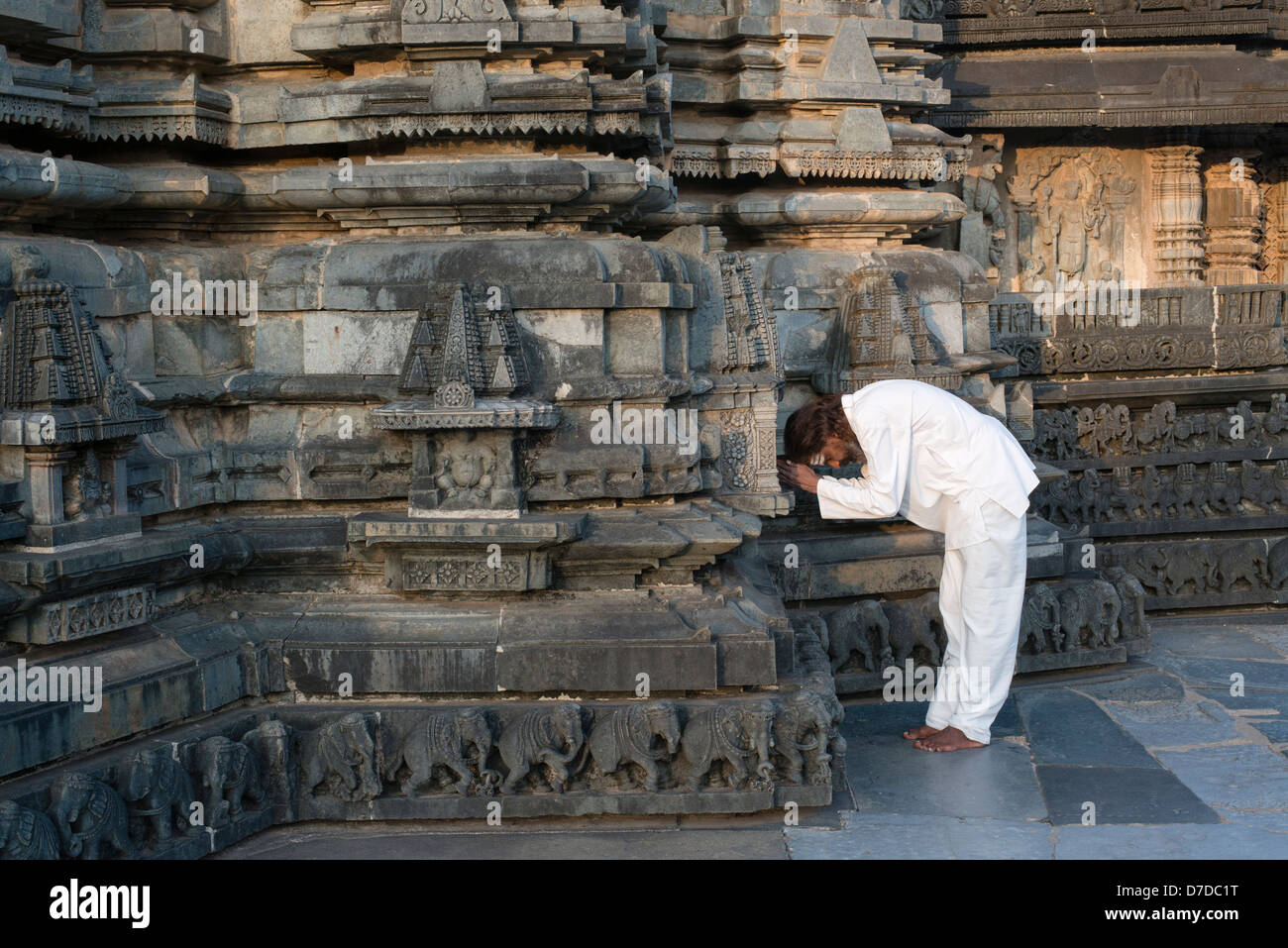 A Hindu Shaivite priest prays before a shrine at the Chennakesava ...