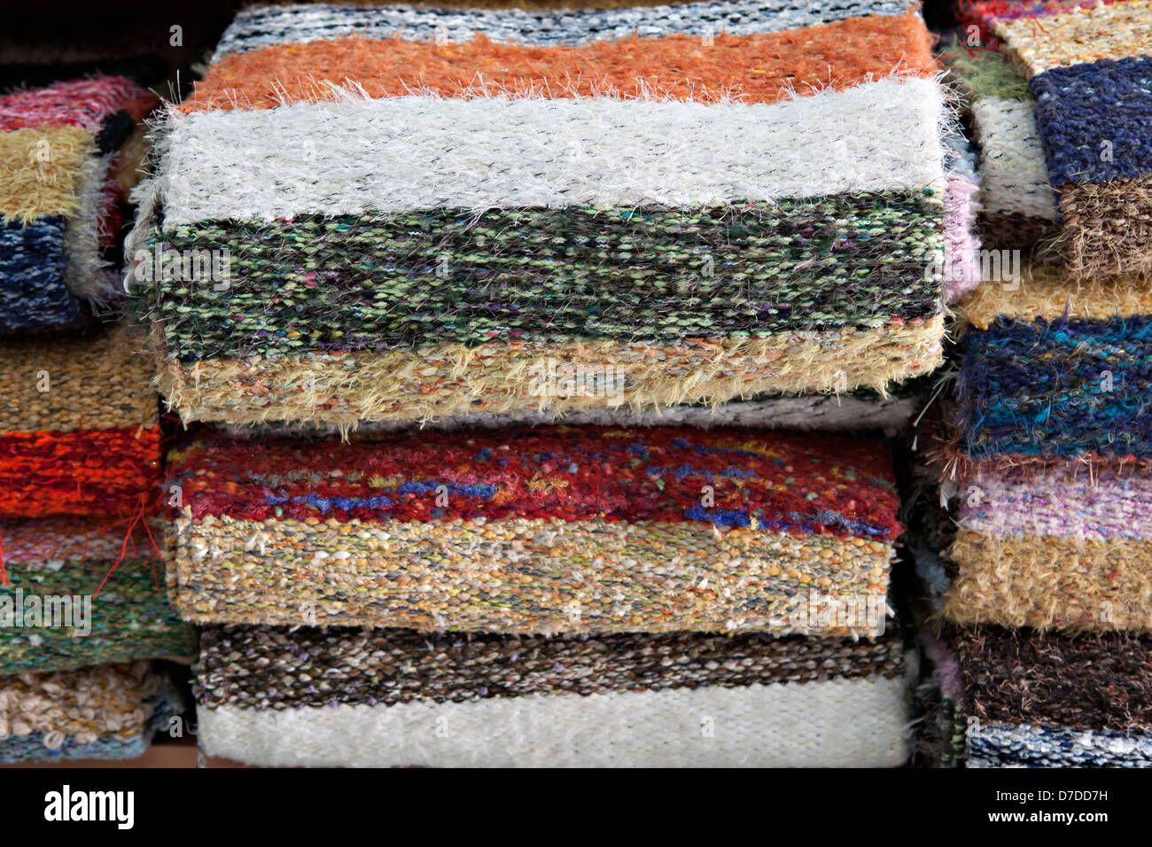 Large group of rugs on shelves Stock Photo - Alamy