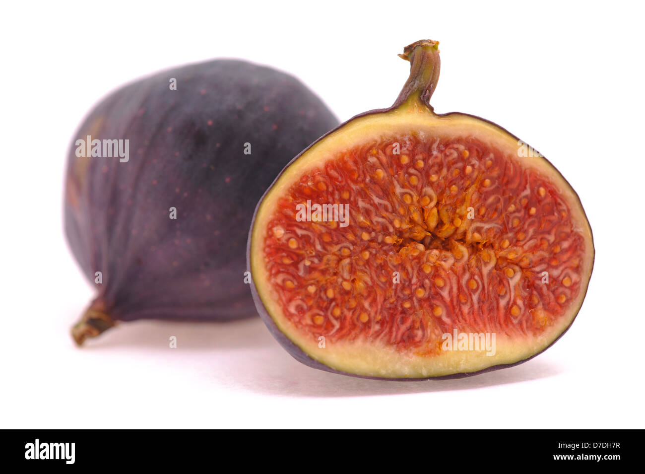 sliced tropical fig over white background Stock Photo - Alamy