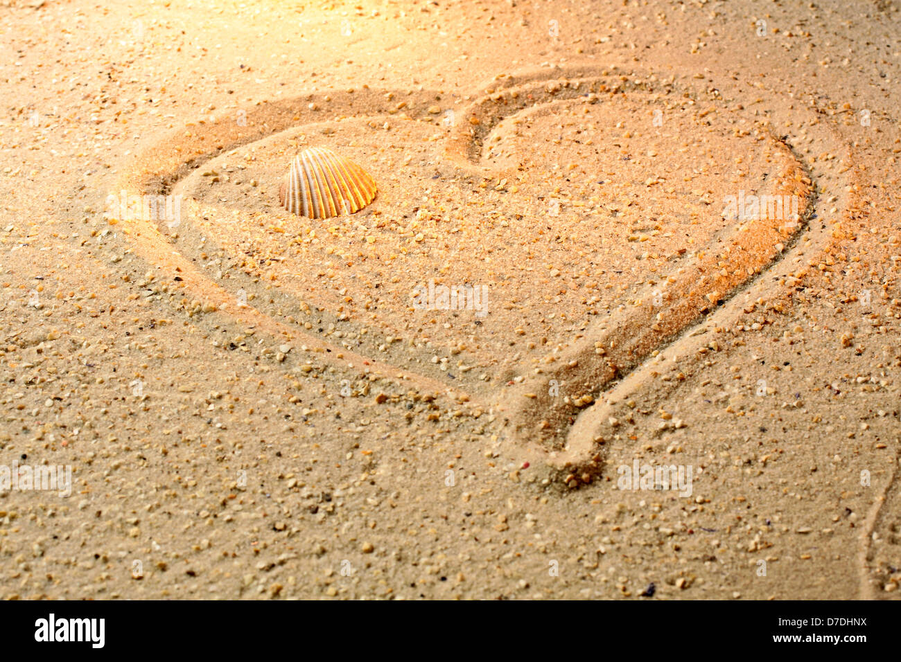 Heart shape in sand with sea shell Stock Photo - Alamy