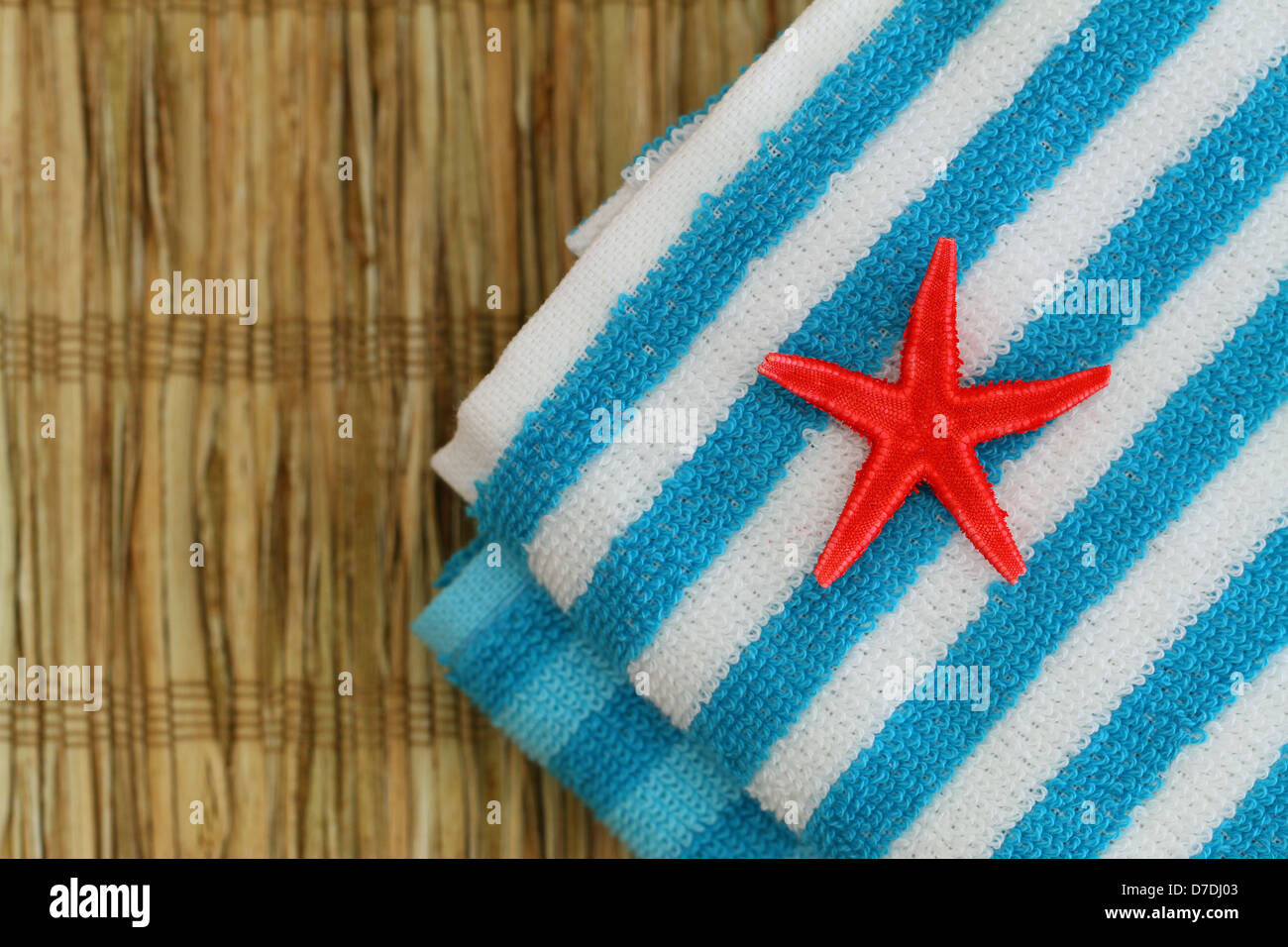 Red starfish on striped towels and bamboo mat Stock Photo - Alamy