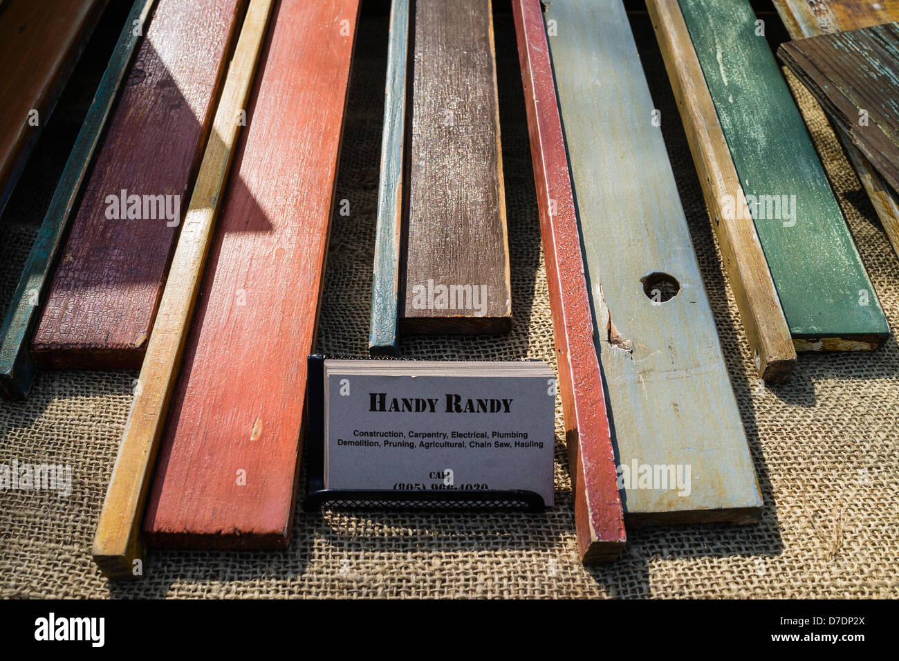 A tabletop display of wood and a business card of a handyman that goes ...