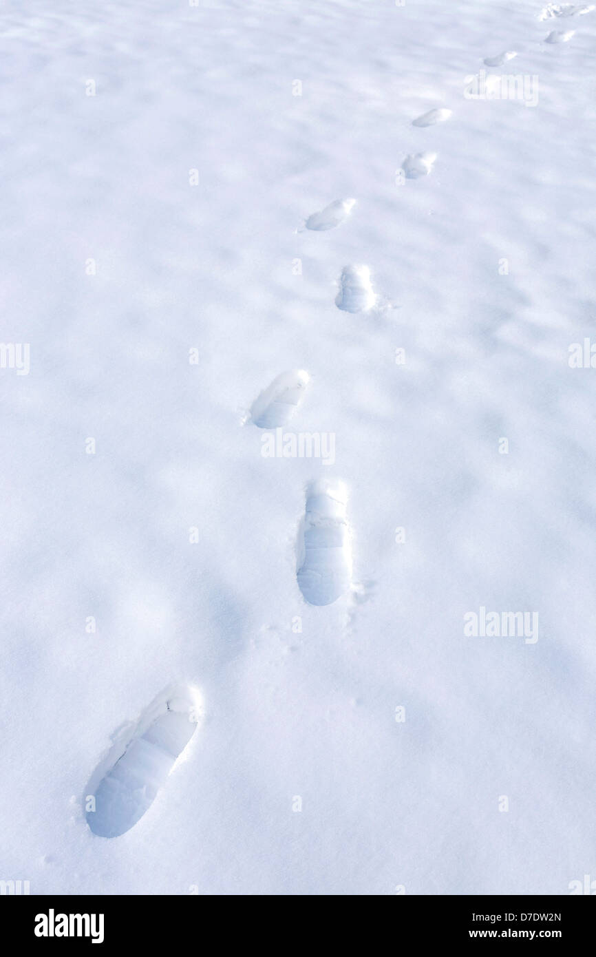 Foot steps on white snow Stock Photo - Alamy