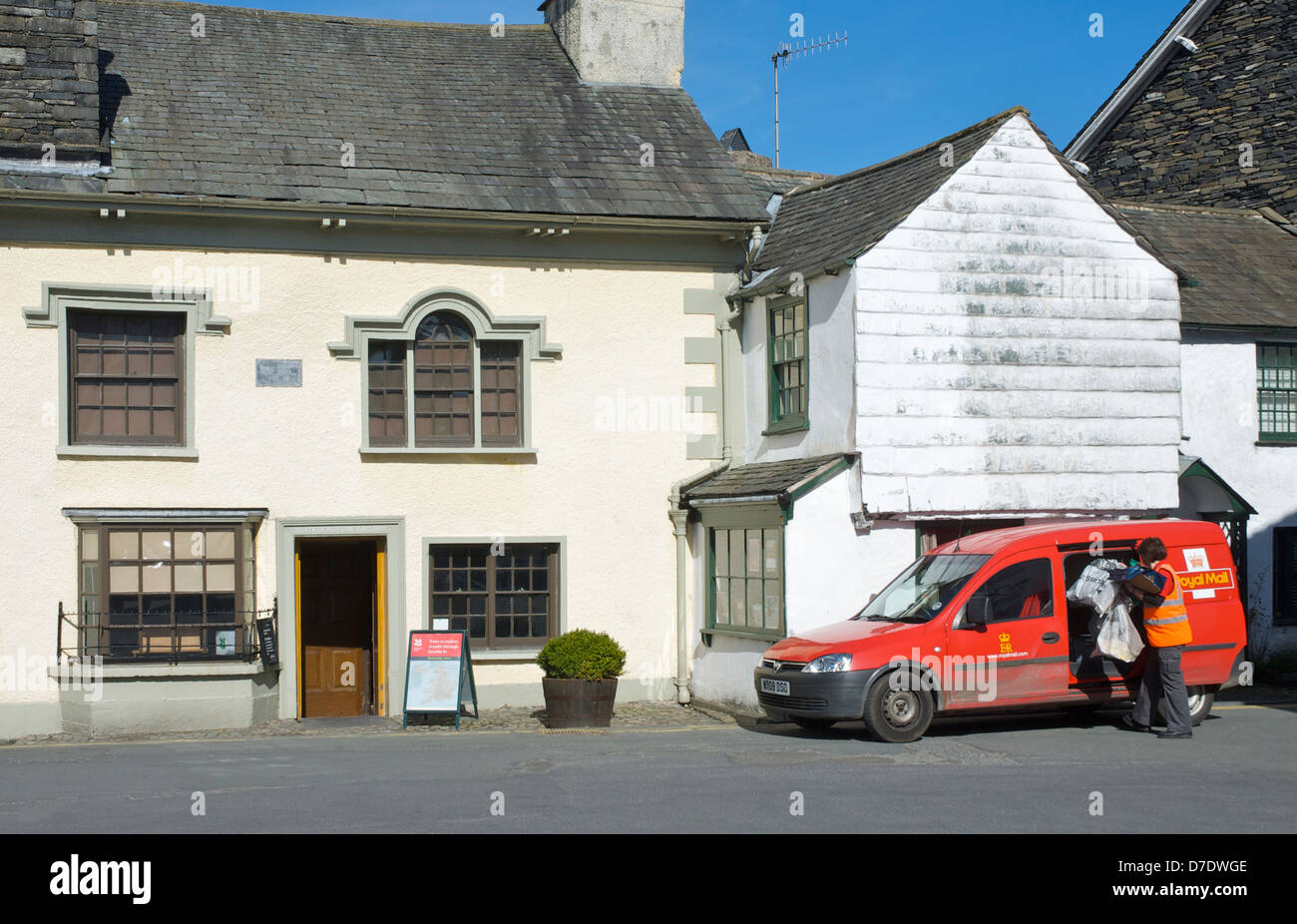 Woman loading bags into Royal Mail van outside Beatrix Potter Gallery ...