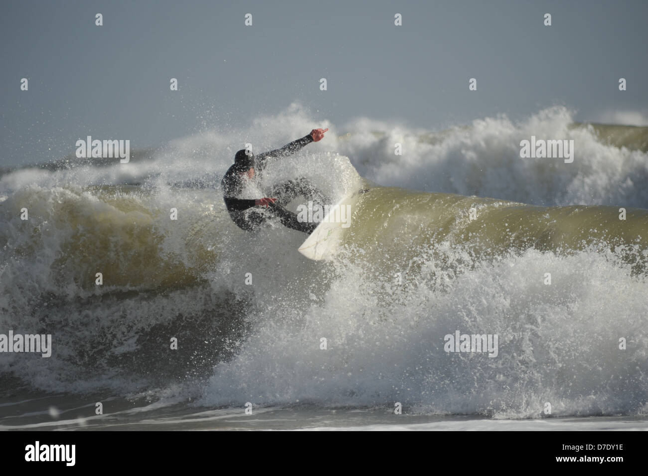 the surfer times his turn to coincide with the full force of the ...