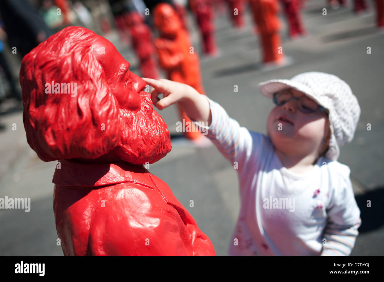 A small girl touches a Karl Marx figure by conceptual artist Ottmaer ...