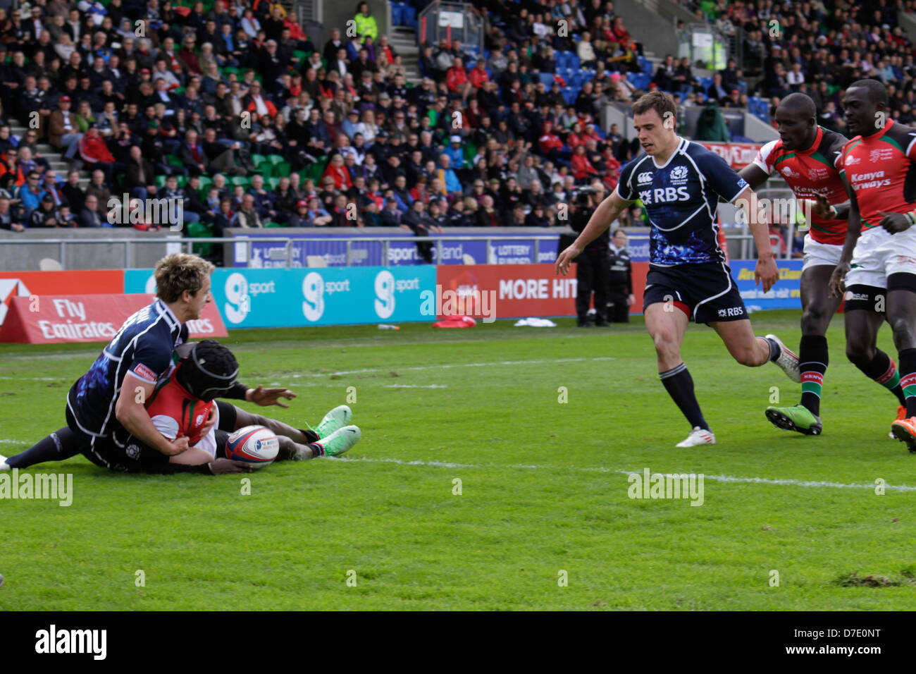 Felix Ayange scores a try for Kenya as Scotland's Alex Glashan tackles ...