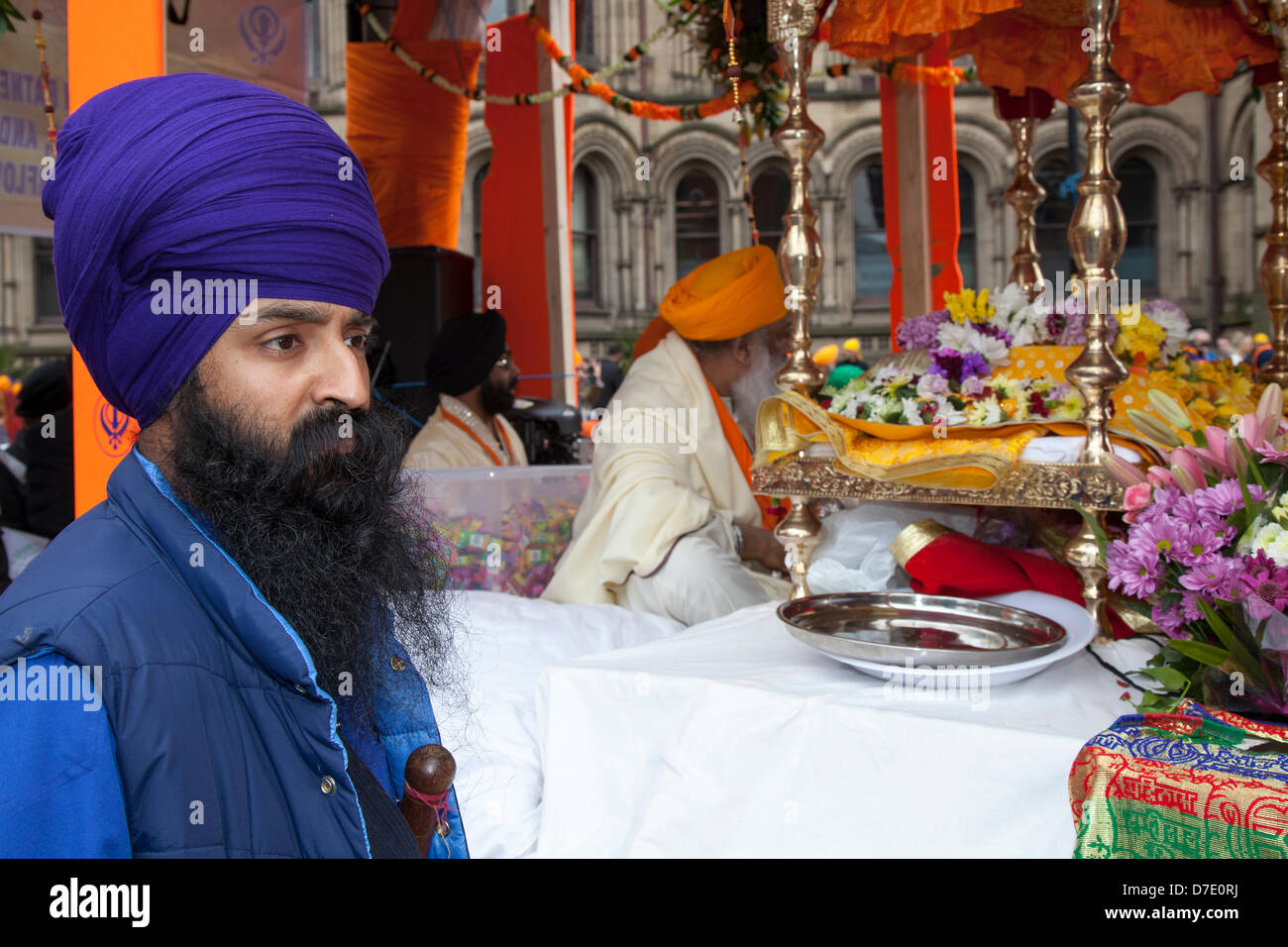 Manchester, UK. 5th May, 2013. Seated Sikh Guru and a Mail-clad officer ...