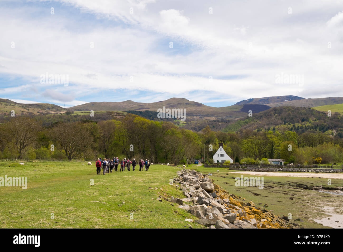Ramblers walking on Wales Coastal Path through Glan y Mor Elias coastal ...