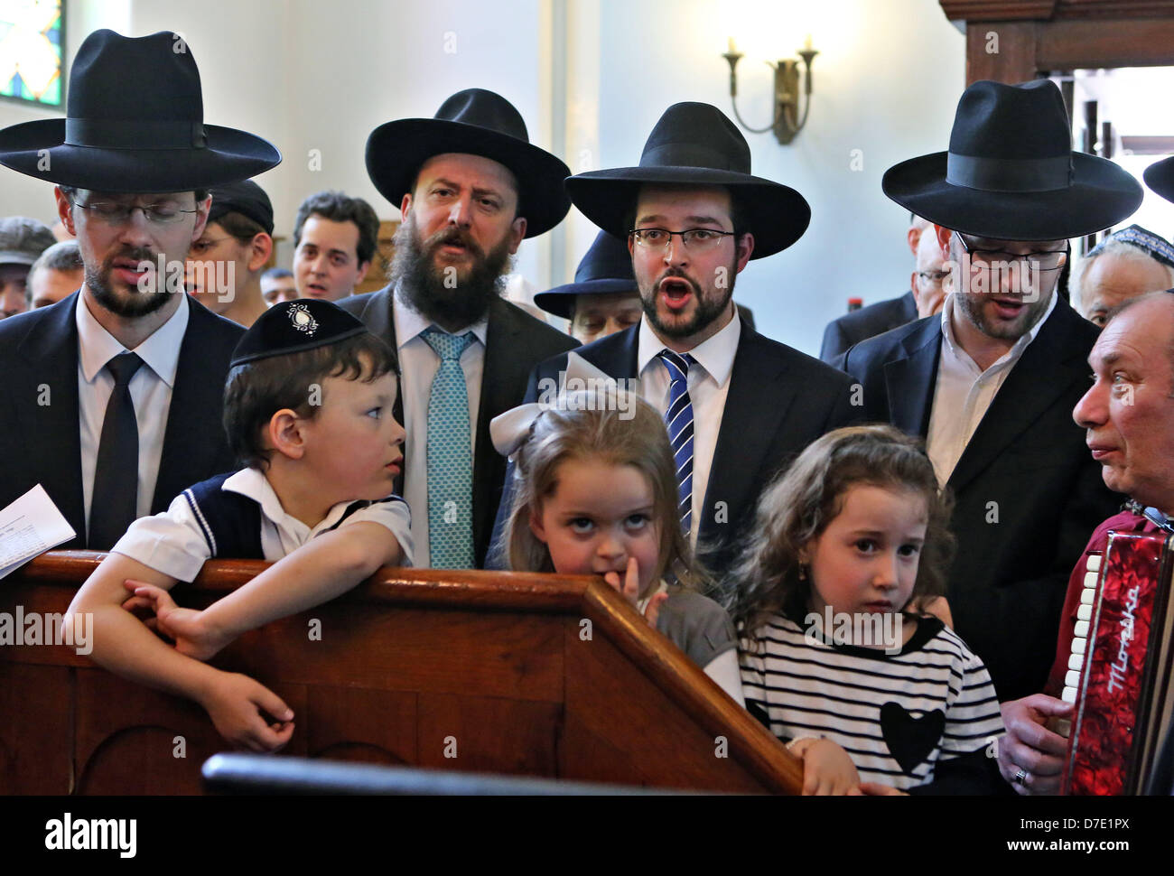 Hewish clergymen sing as a new Torah scroll is carried into the ...