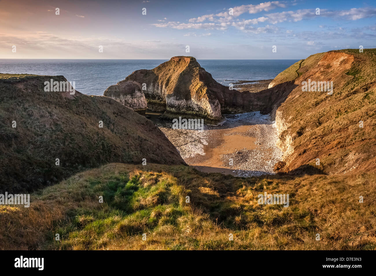 High chalk cliffs and evidence of sea erosion photographed at dawn with ...