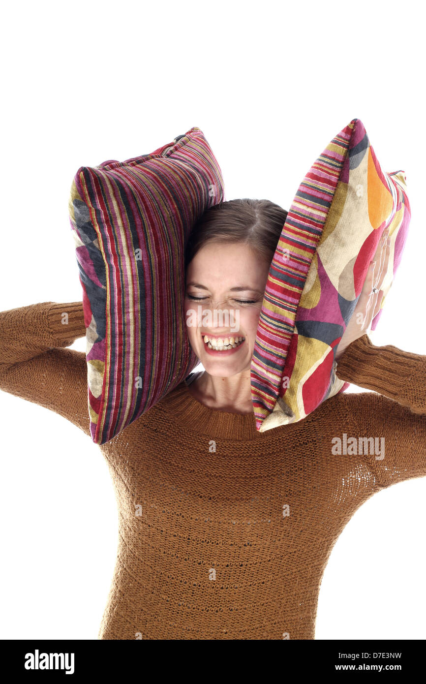 A very angry and frustrated woman screaming and covering her ears ...