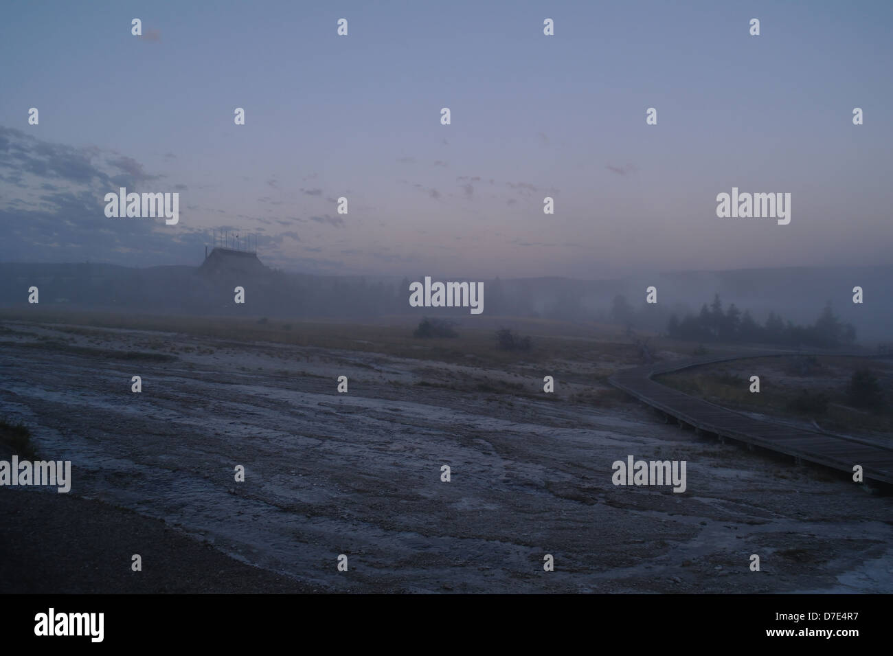 Dawn twilight view west across Old Faithful overflow slope to steam fog ...