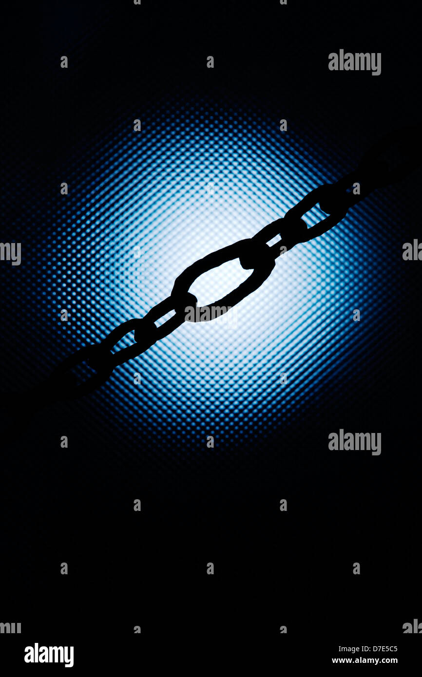 Strong metal chain in front of bright light Stock Photo - Alamy