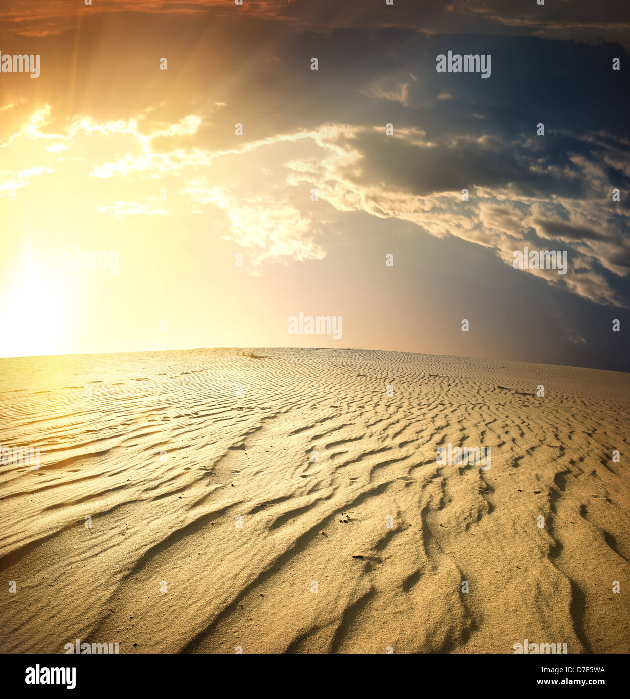 Desert into the sunset and dramatic clouds Stock Photo - Alamy