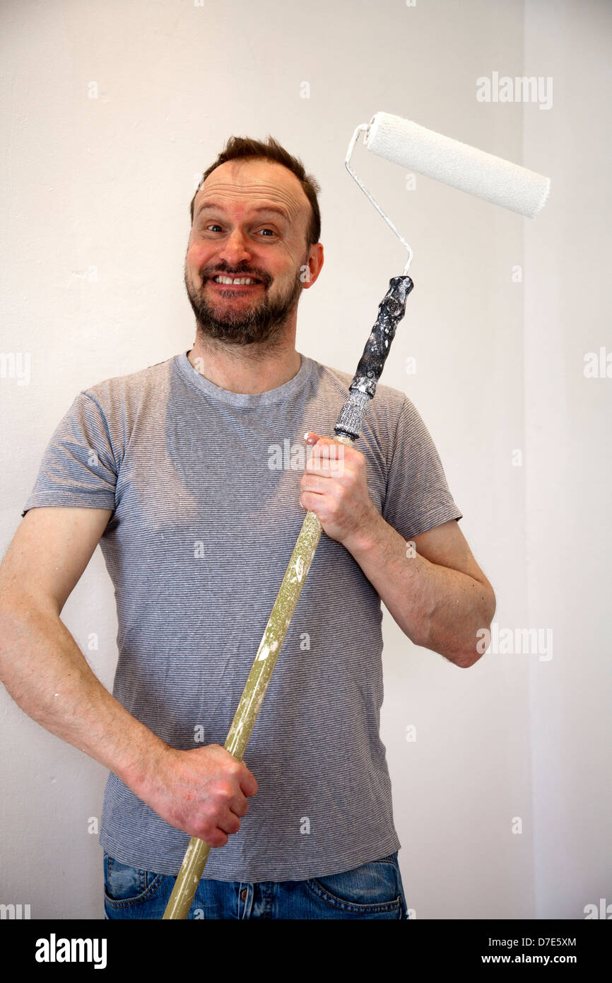 Man with paint roller hi-res stock photography and images - Alamy