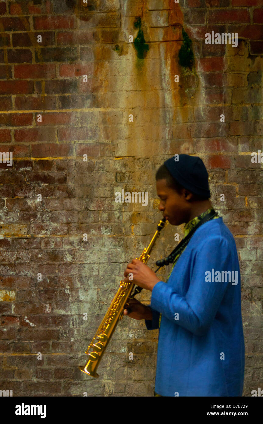 Busker trumpeter playing under Southwark bridge, London Stock Photo - Alamy