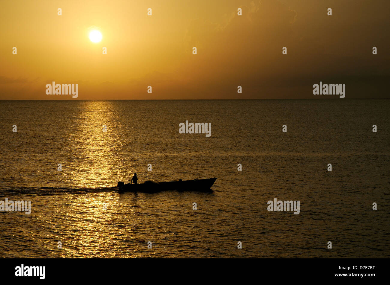 Fishing Boat at Sea at Sunset Stock Photo - Alamy
