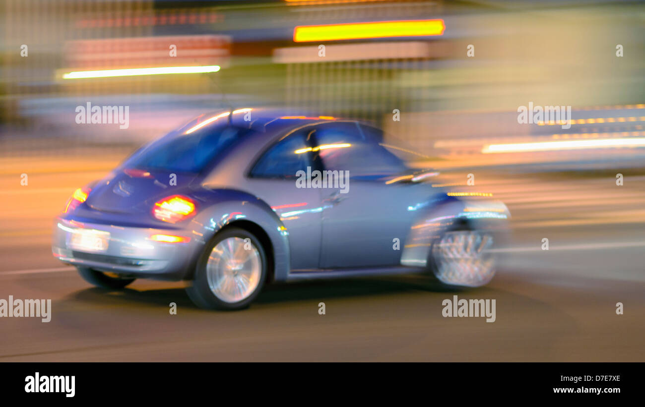 a speeding car and blurry streetlights behind Stock Photo - Alamy
