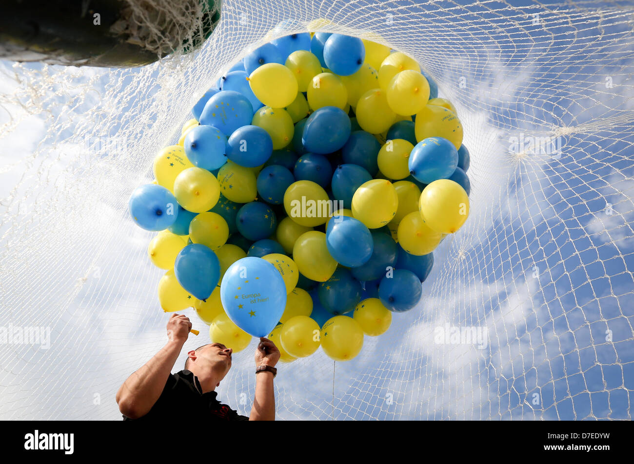Martin Mogk inflates balloons lettered 'Eurpoe is here' at the Europe ...