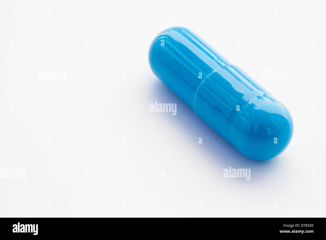 blue medicine pill on white background Stock Photo - Alamy